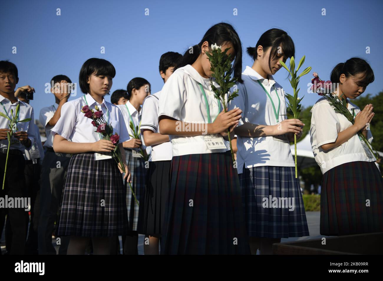 Visitors lays flowers and pray for the atomic bomb victims in front of ...