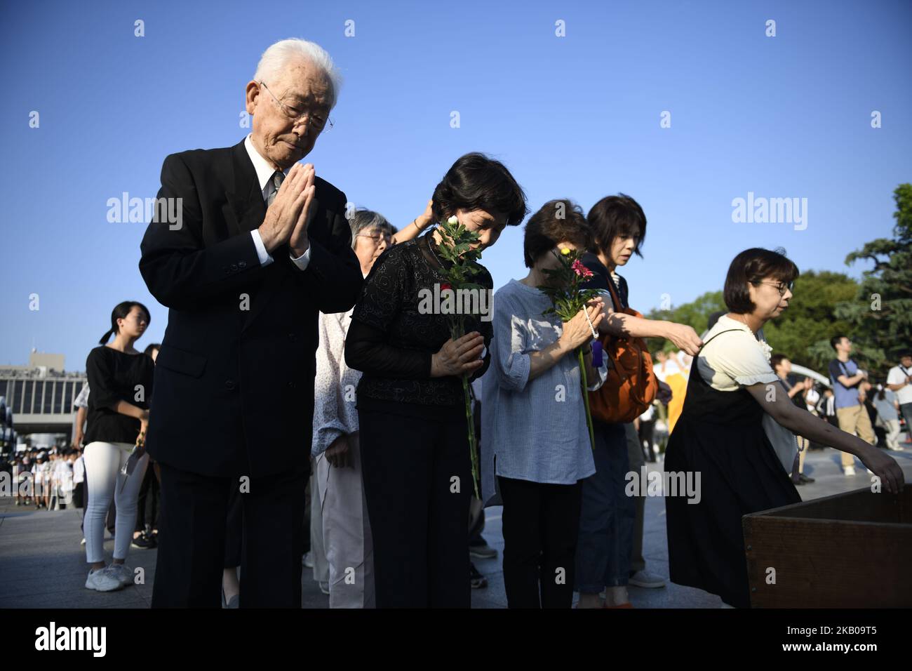 Visitors lays flowers and pray for the atomic bomb victims in front of ...
