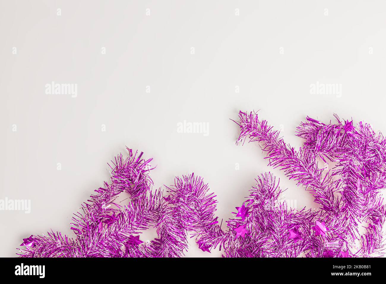 creative festive frame with purple streamers on white background, top ...