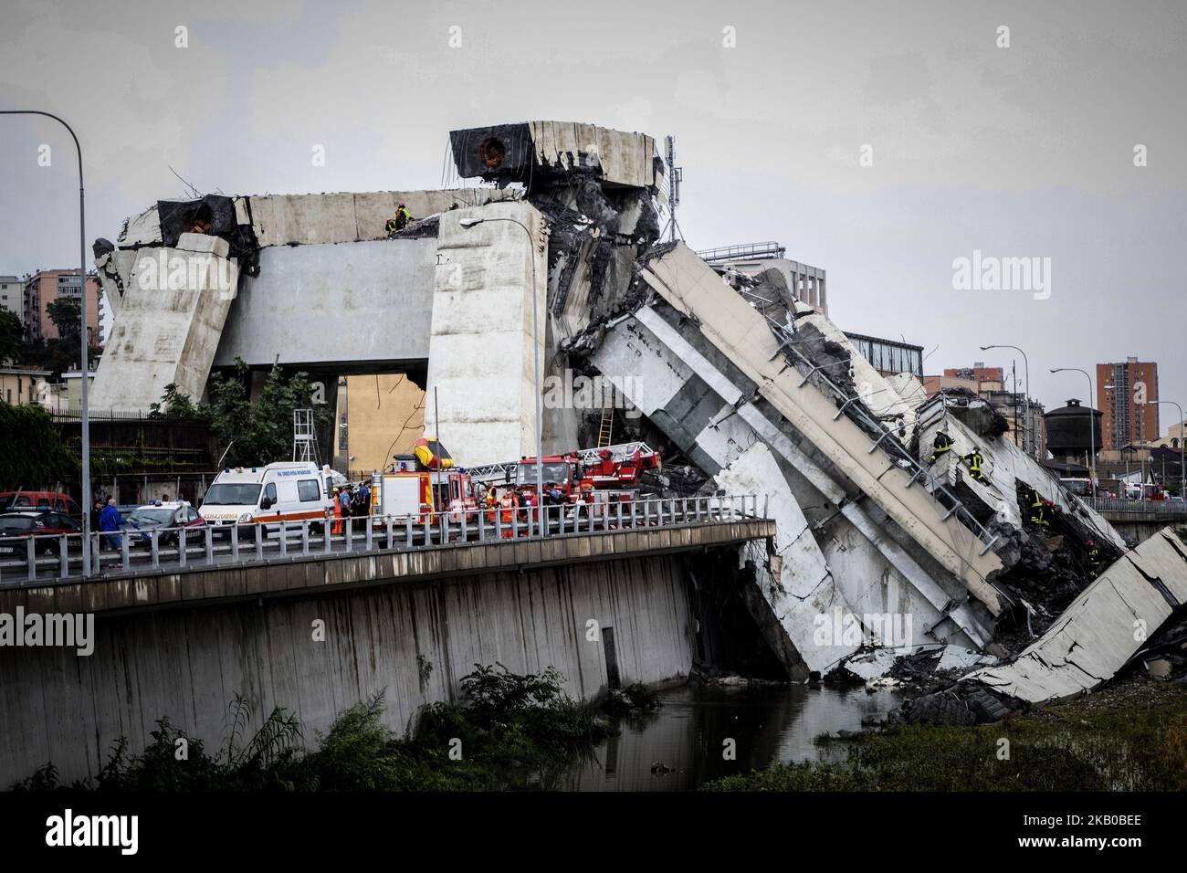 A picture taken on August 14, 2018 shows rescue workers on a part of a ...