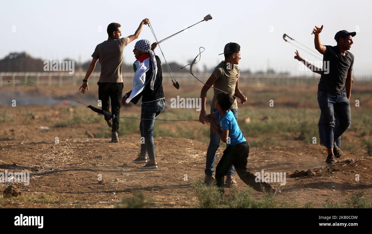A Palestinian demonstrator uses a sling to hurl stones at Israeli ...