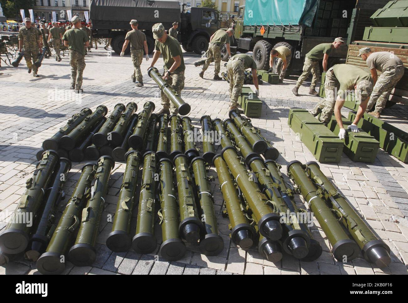 Ukrainian soldiers carry anti-tank missile complexes "Stugna-P", handed ...