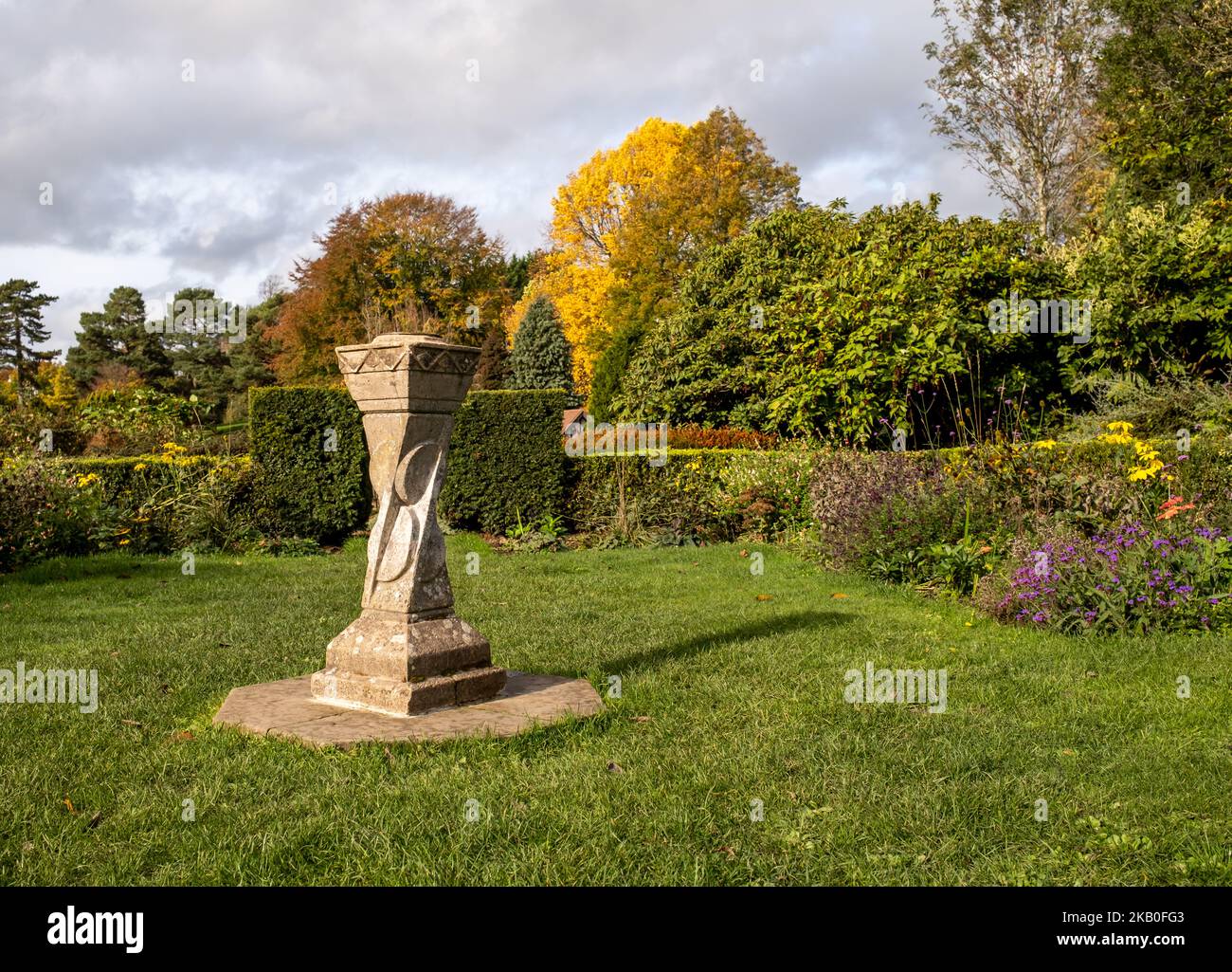 Close and selective focus on a concrete sundial in the garden of a ...