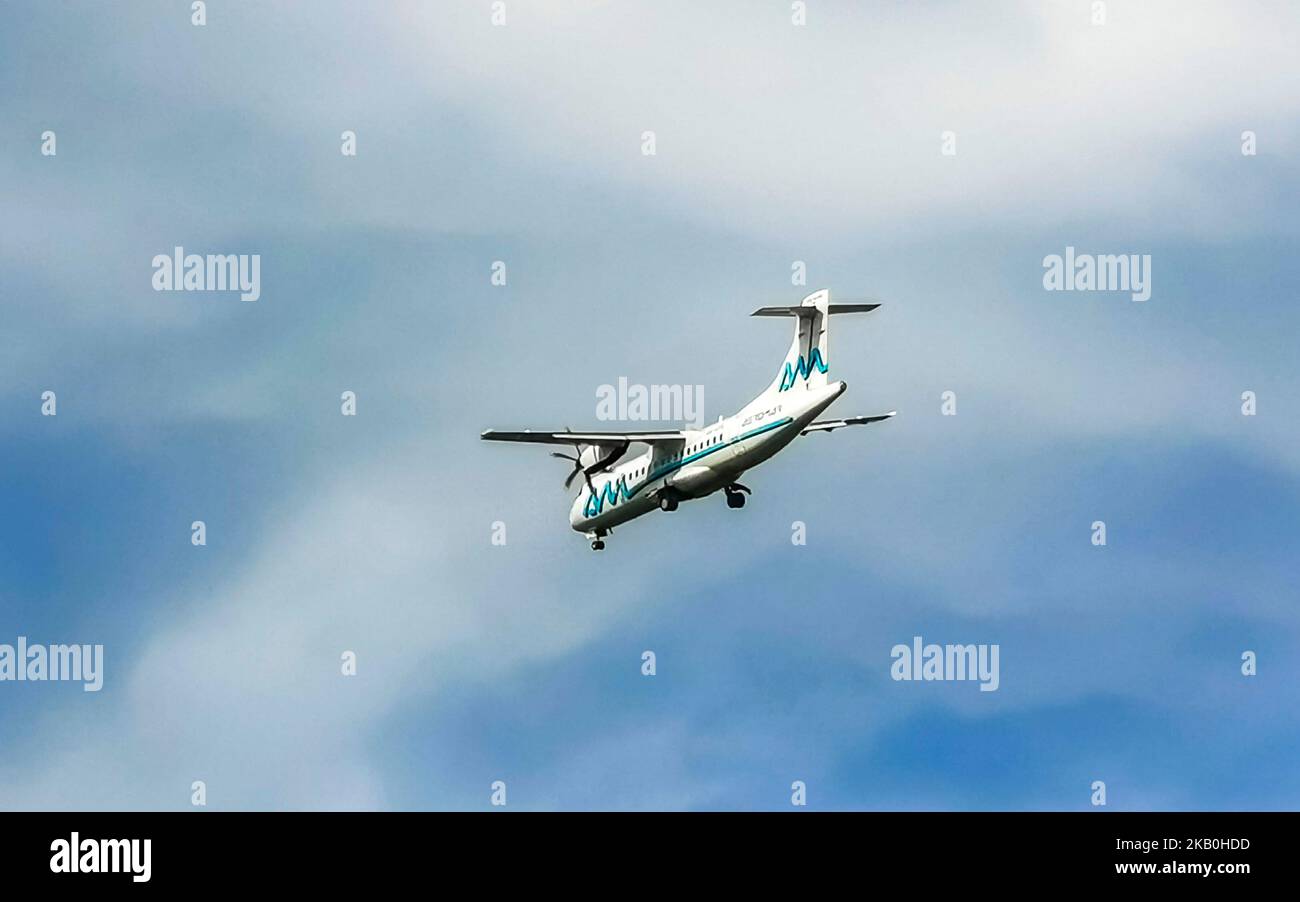 Plane flies thru the clouds with blue sky in Puerto Escondido zicatela Oaxaca Mexico Stock Photo ...
