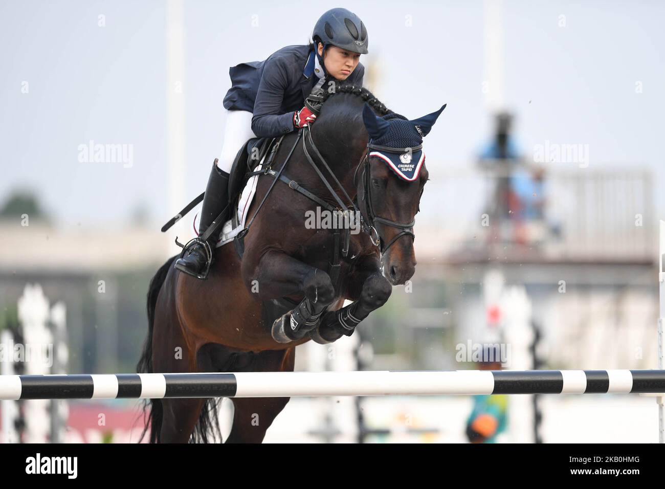 Chinese Taipei's equestrian competes in the jumping team final at the ...
