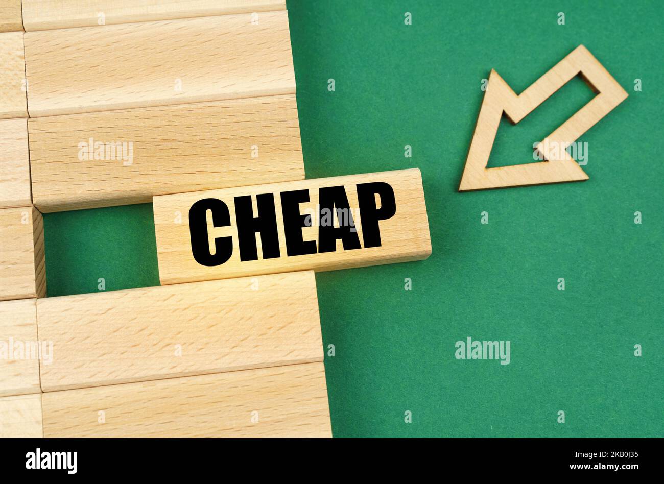 Business concept. On the green surface are wooden plates and an arrow ...