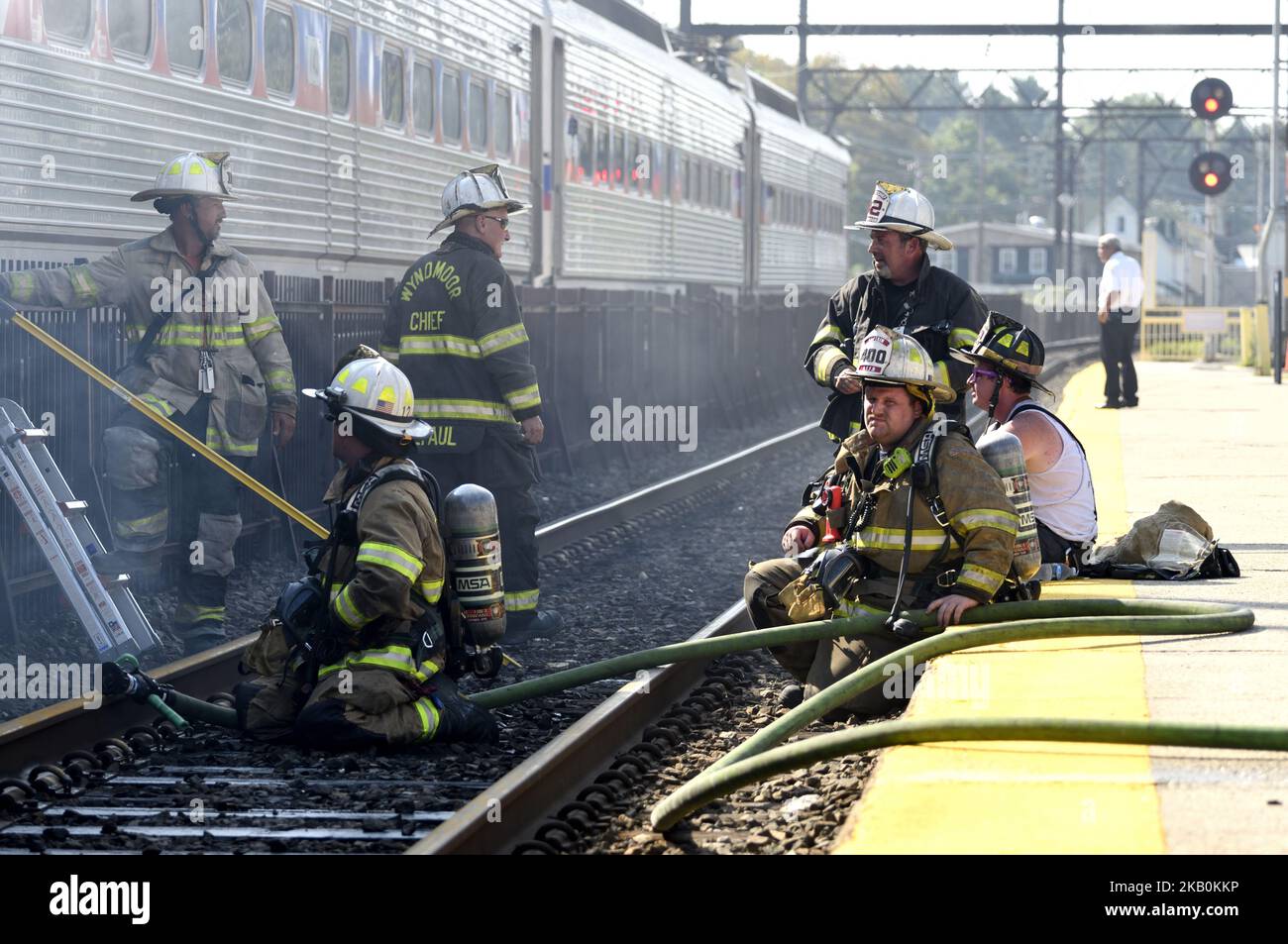 With a triple digits heat index, firefighters battle a fire on a ...