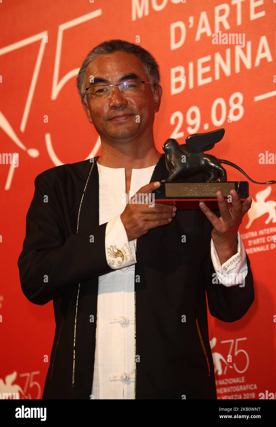 Pema Tseden poses with Orizzonti Award for Best Screenplay Award forJinpa at the Winners ...