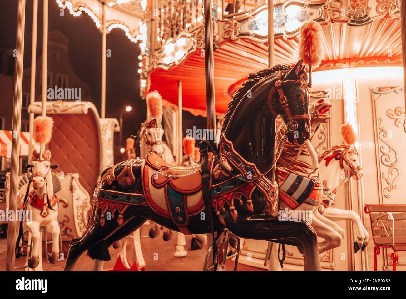 Old carousel in the park. Three horses and a plane on a traditional ...