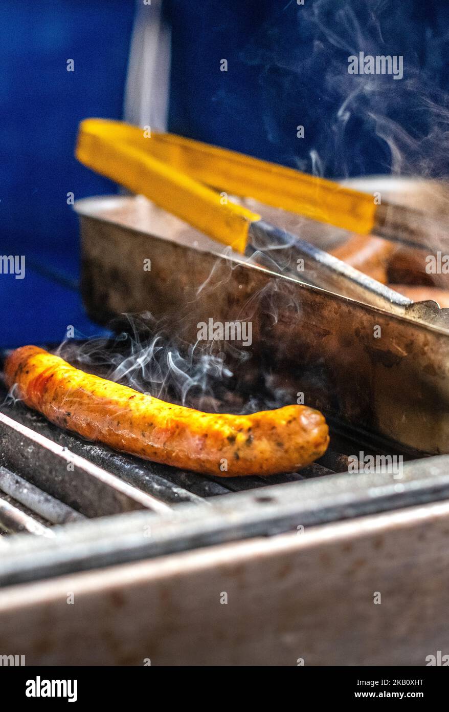 Closer sausage on a griddle being cooked steam coming from the sausage ...