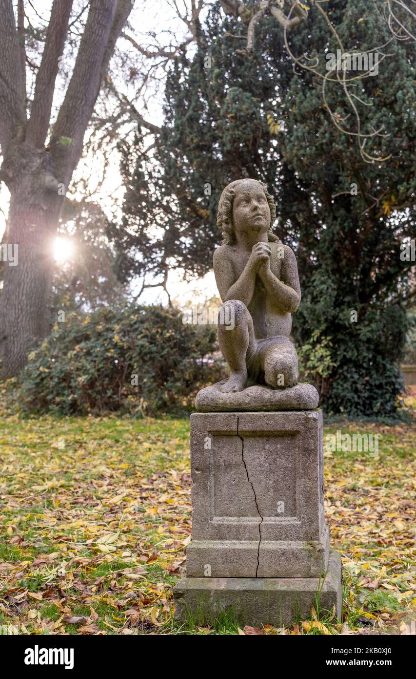 Religious Christ Child stone statue in a church yard Stock Photo - Alamy
