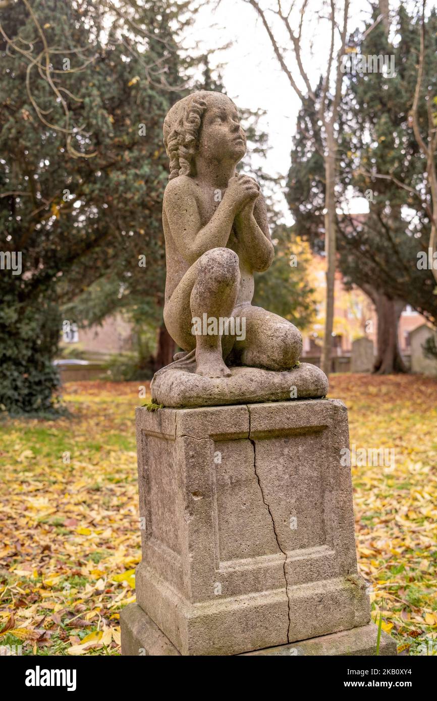 Religious Christ Child stone statue in a church yard Stock Photo - Alamy