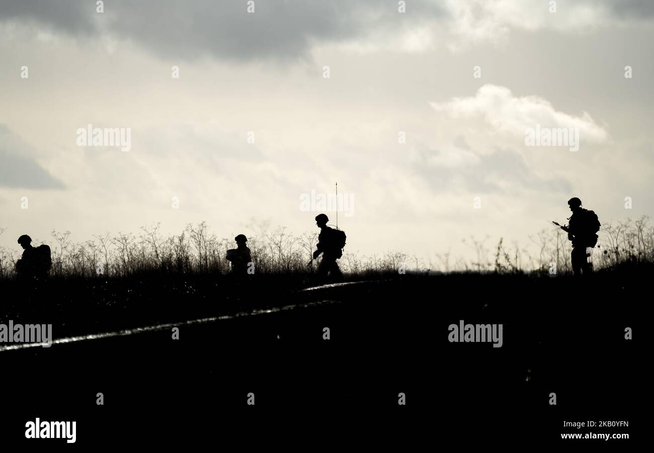 silhouetted British army soldiers on a military training exercise in ...