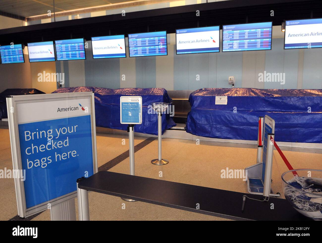 Ticket counters are seen covered with tarps at an empty Charleston ...