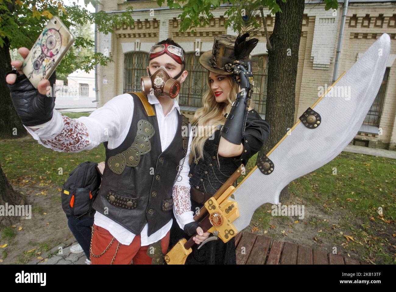 Participants dressed in steampunk cosplay costumes attend the ...