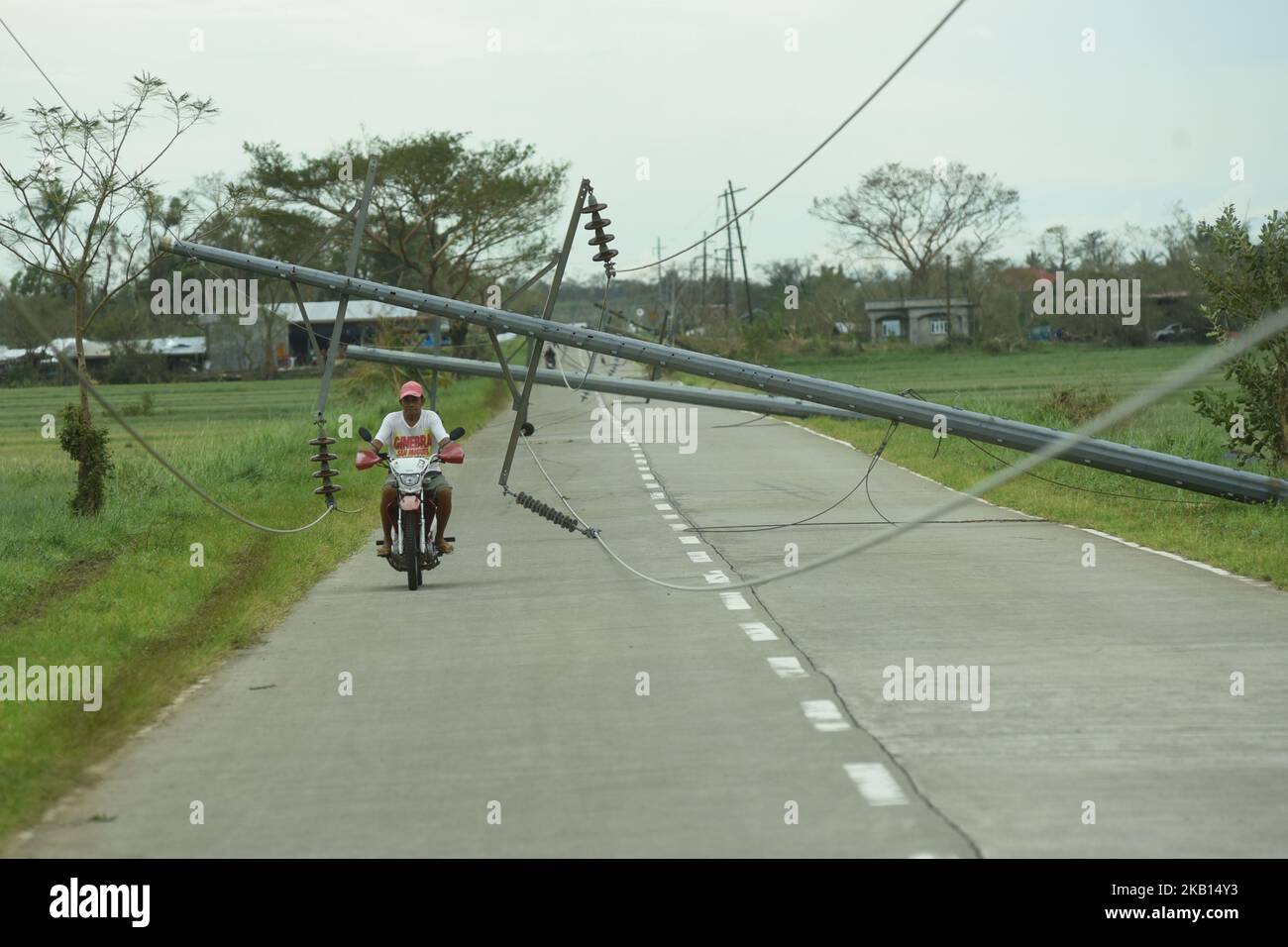 A vehicle attempts to get past toppled electrical posts in Sta ...