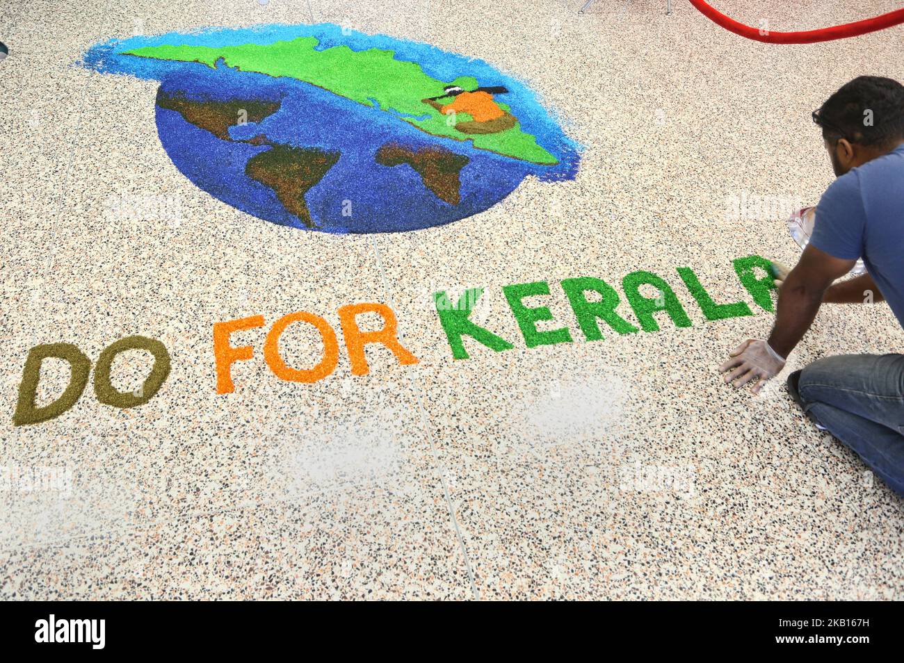 Youth create a colourful rangoli (rangoli, also known as kolam, is a ...