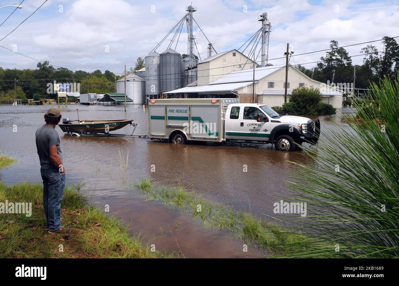 Conway, South Carolina, United States - A man views a flooded road in ...