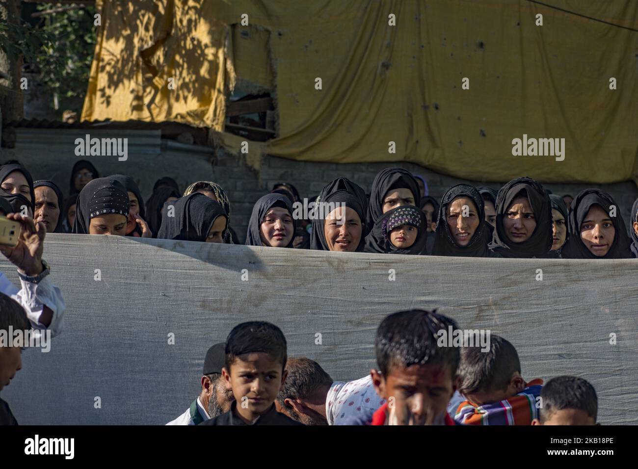 Kashmiri Shiite women look towards men flagellating themselves on the ...