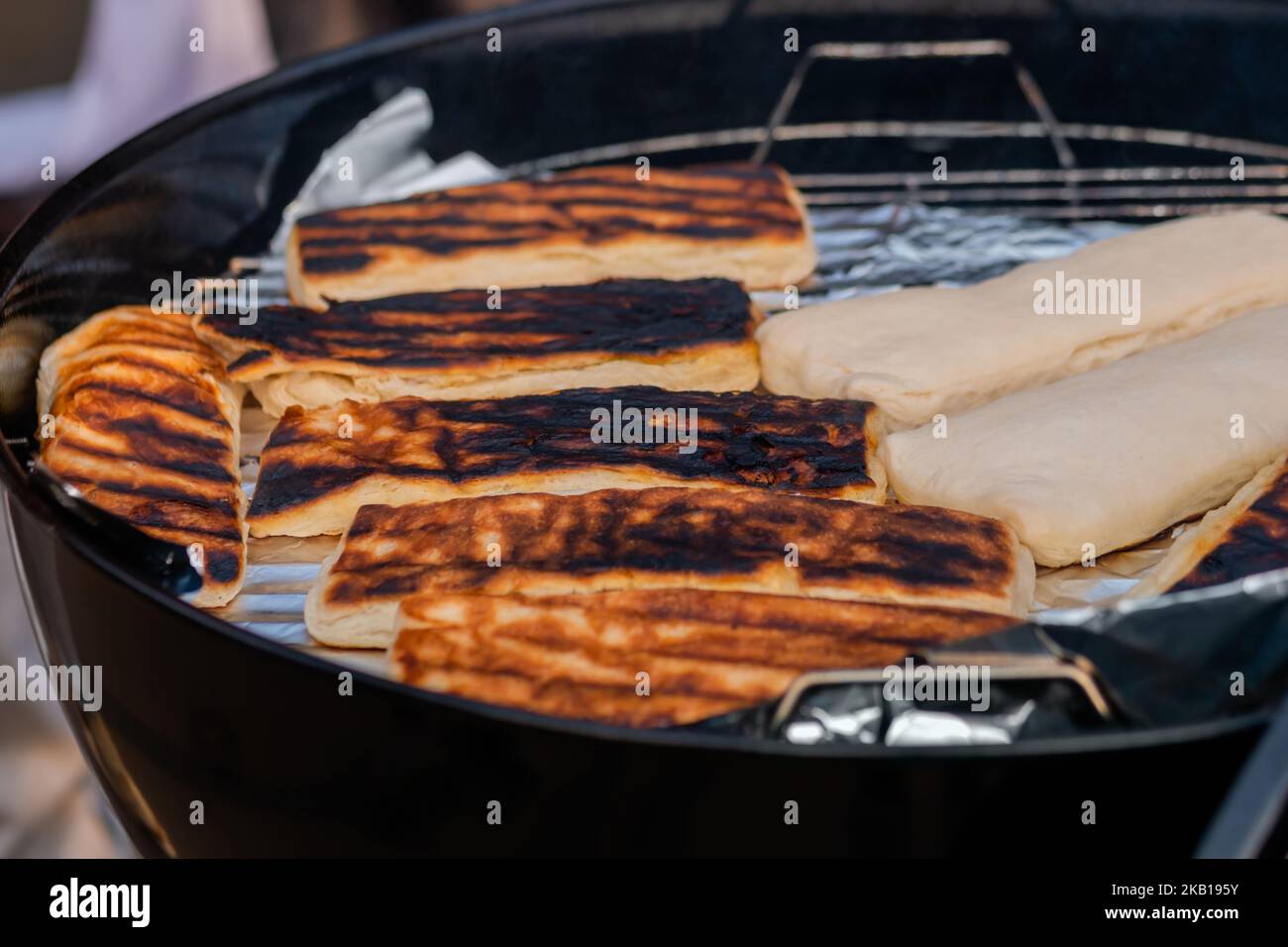 Process of cooking doner kebab on grill at street food festival Stock ...