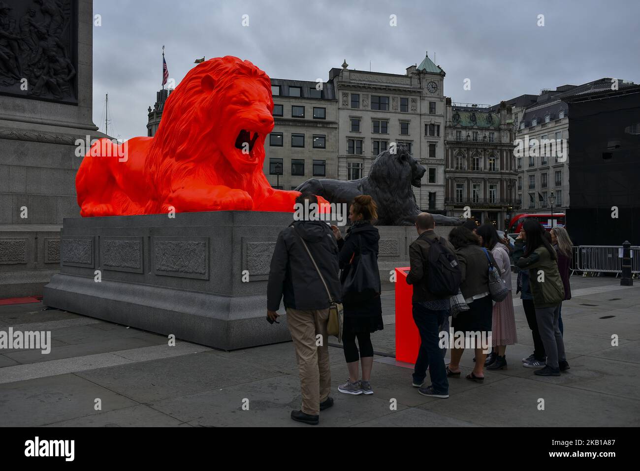 An installation featuring a bright red lion titled 'Please Feed The ...