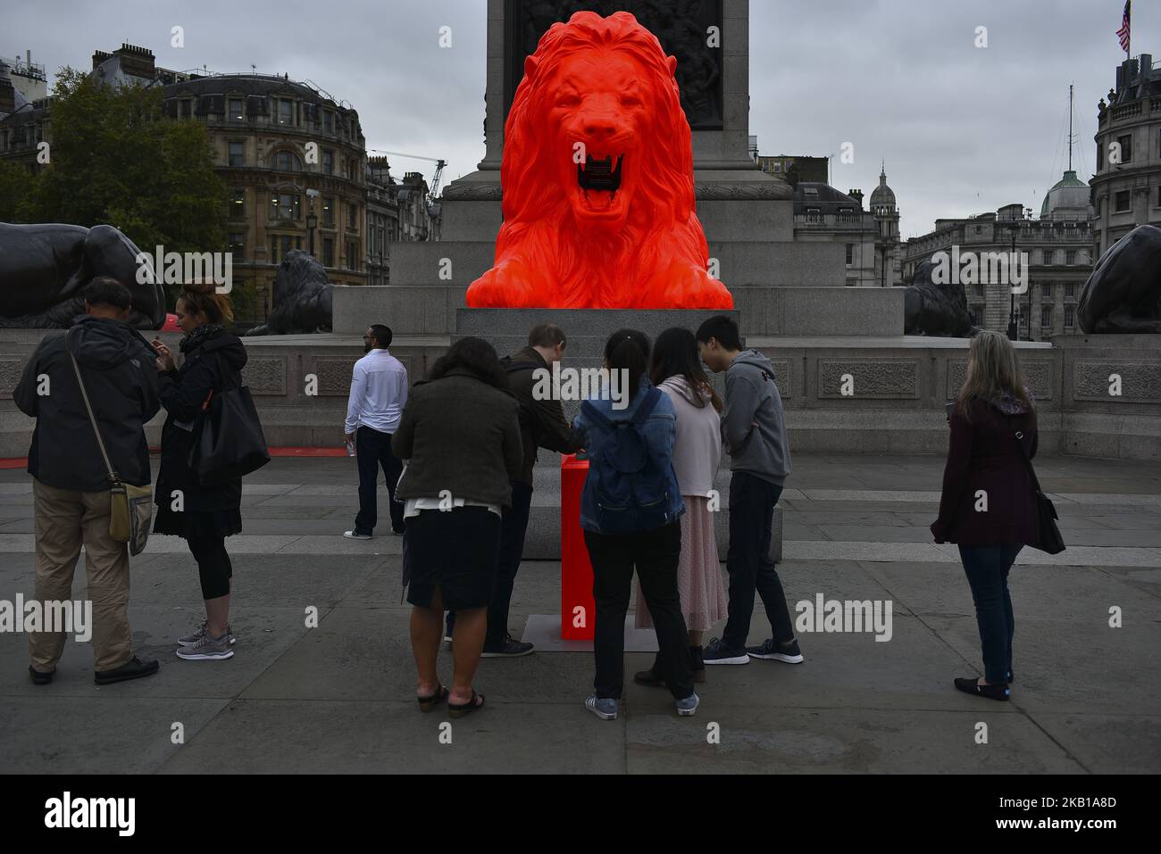 An installation featuring a bright red lion titled 'Please Feed The ...