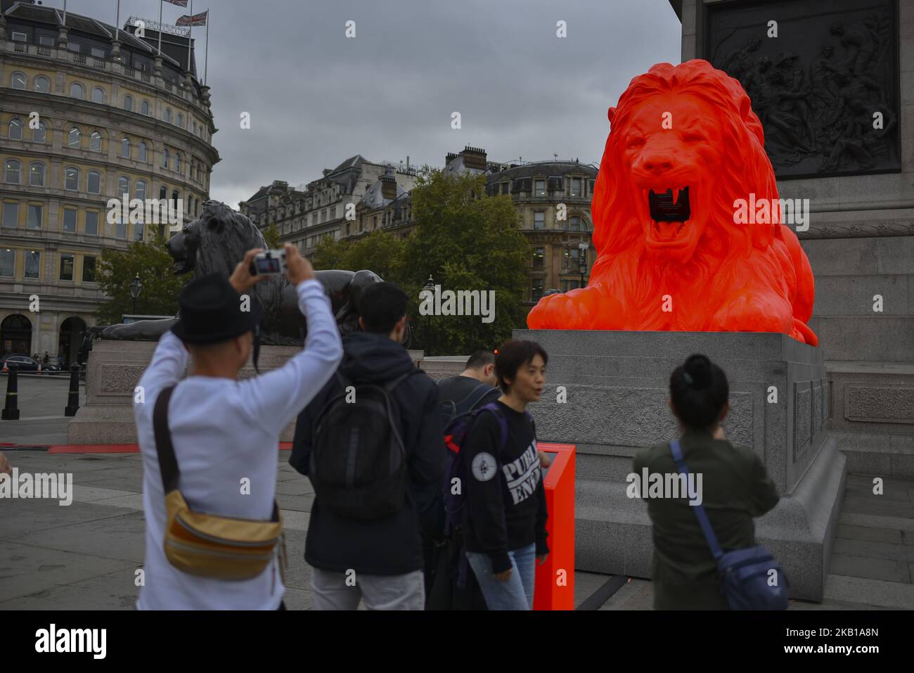 An installation featuring a bright red lion titled 'Please Feed The ...
