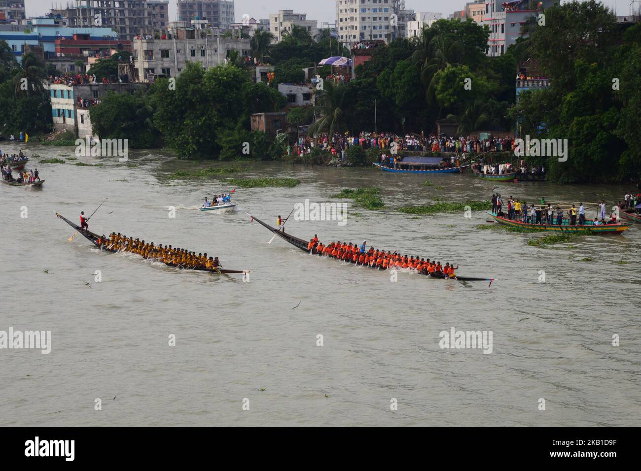 Bangladeshi men row during a traditional boat race in the Buriganga ...