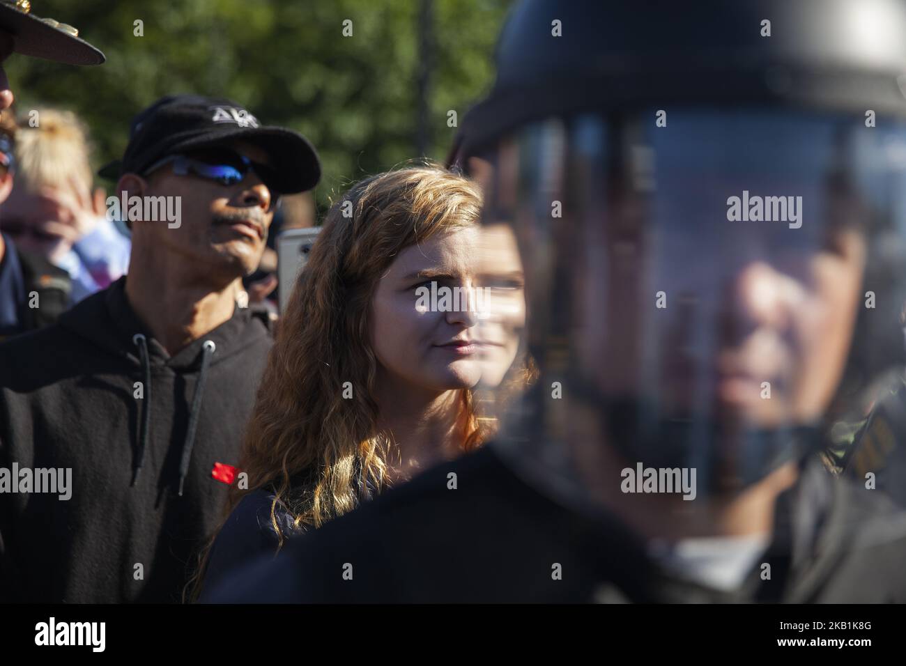 Kaitlin Bennett, a a squad of Three Precenter Milita members and a wall ...