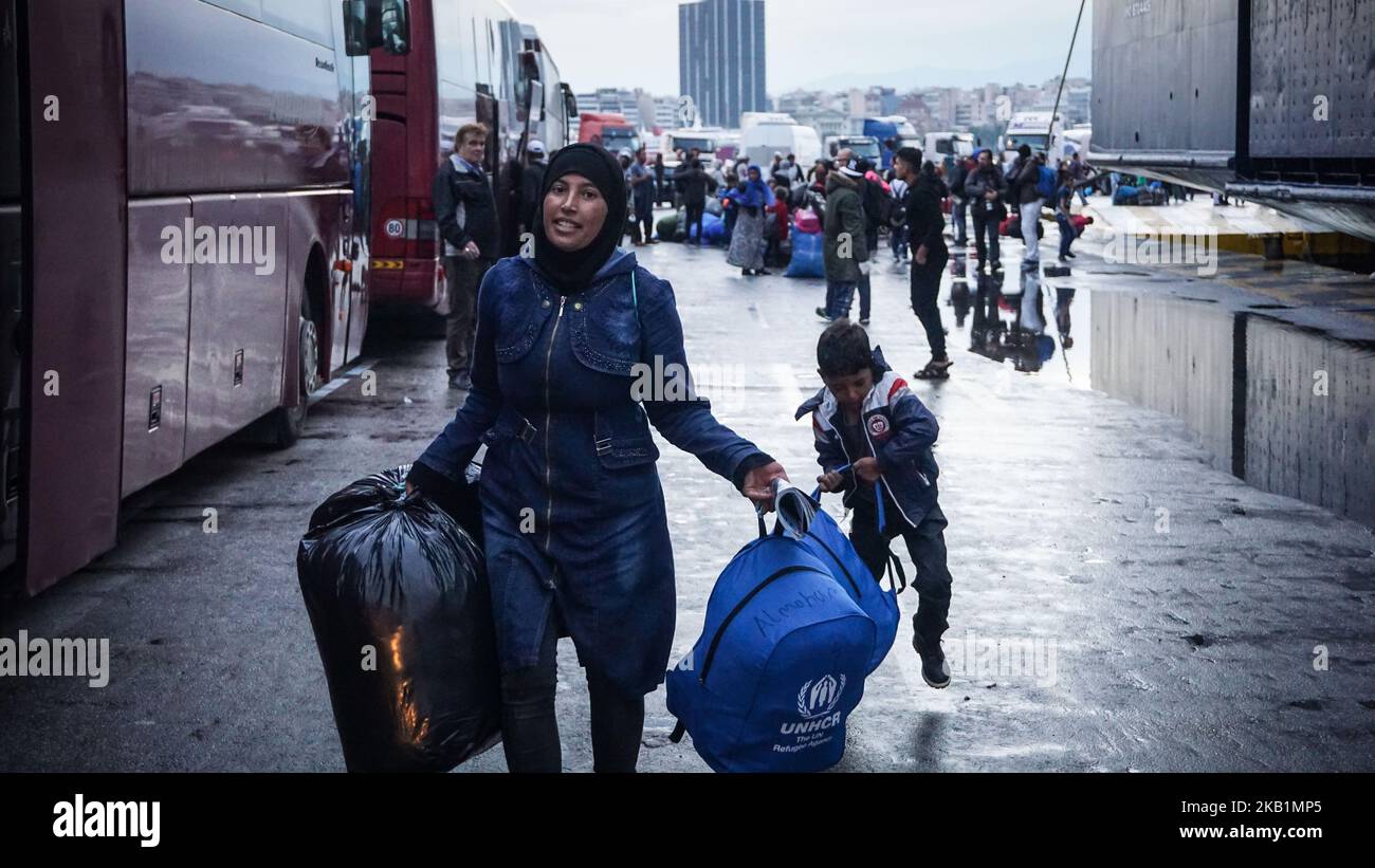 A refugee family carry its belonging items , following disembark at the ...