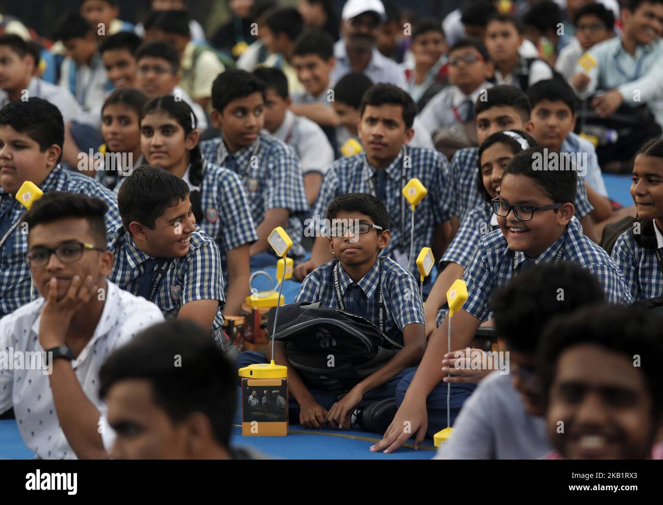 Students hold up solar lamps as they break the world record for for ...