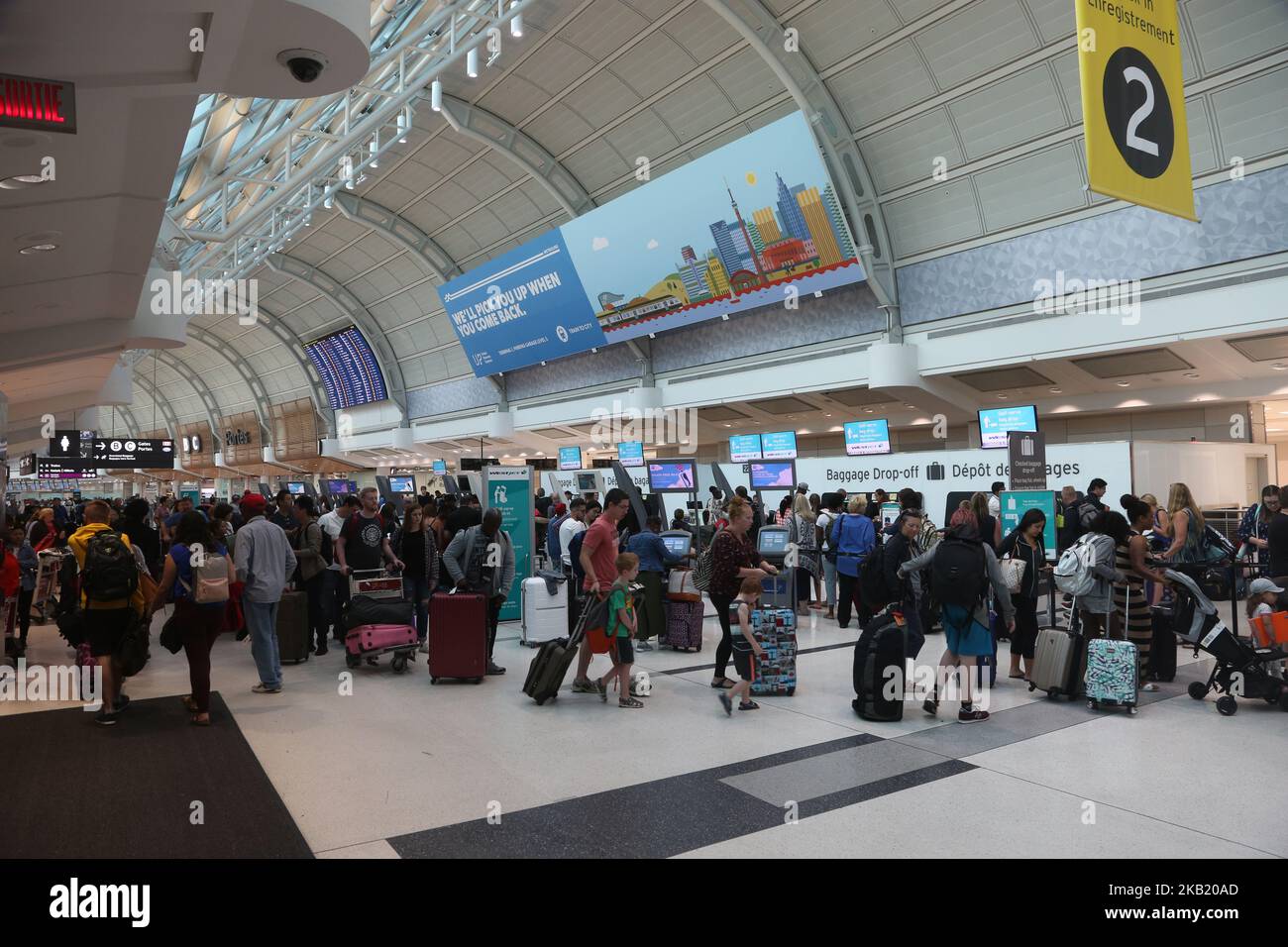 Passengers check in for flights at Lester B. Pearson International ...