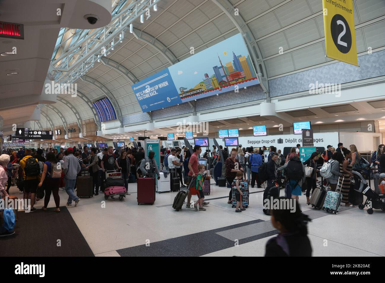 Passengers check in for flights at Lester B. Pearson International ...