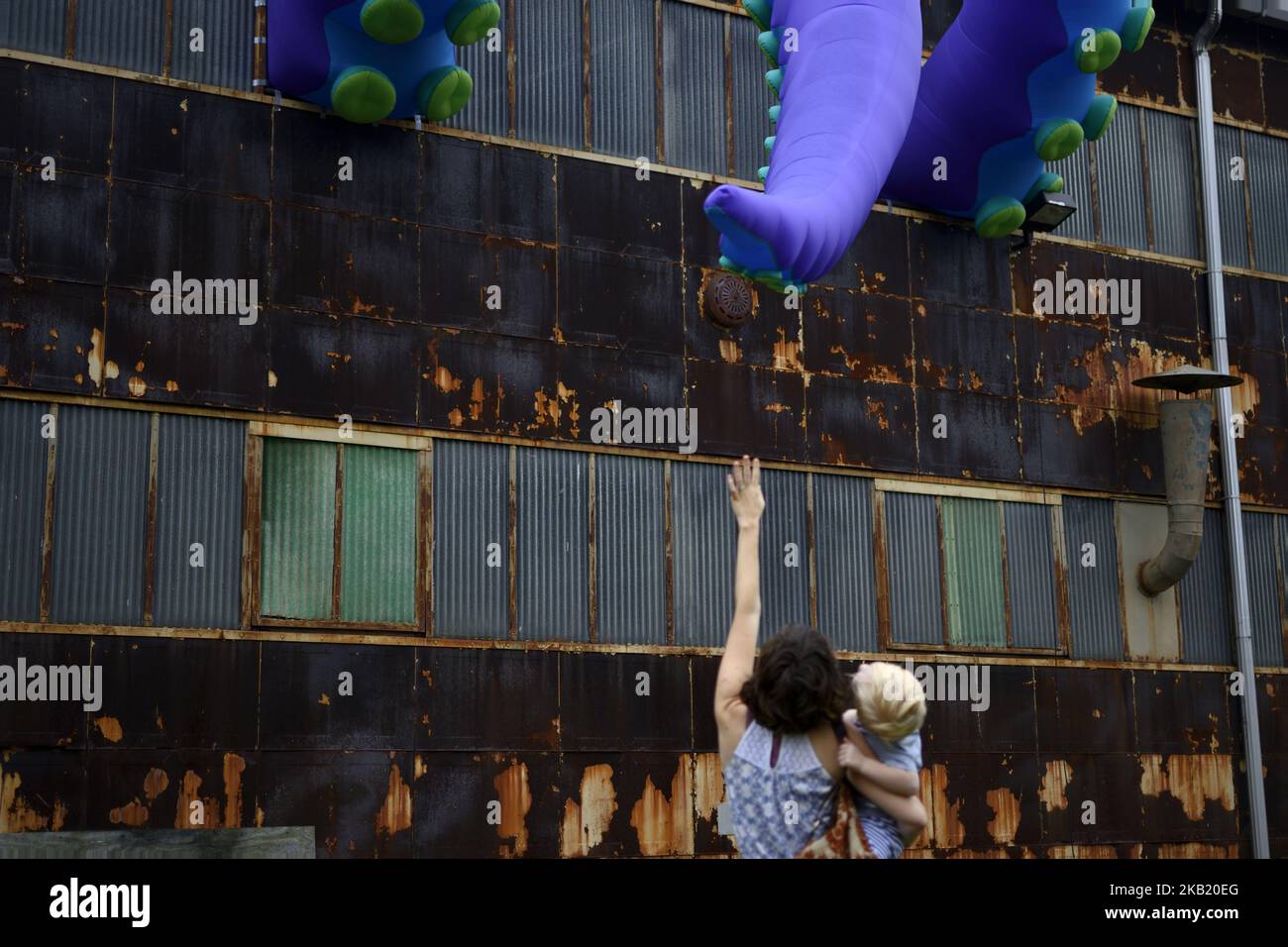 Spectators interact with the inflatable tentacles of a commissioned art ...