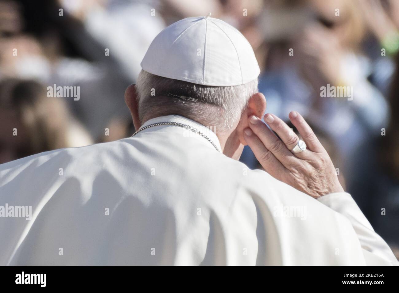 Pope Francis touches his ear as he arrives with the popemobile in St ...