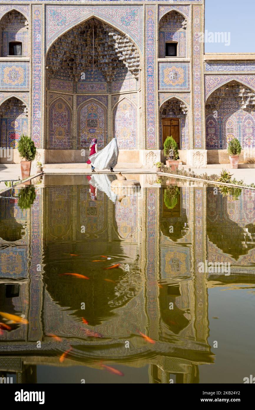 Iranian woman walk on a yard of Nasir al-Mulk Mosque, called the Pink ...