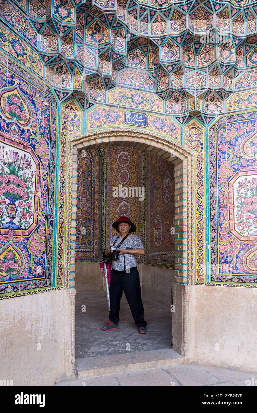 Asian tourist on a yard of Nasir al-Mulk Mosque, called the Pink Mosque ...