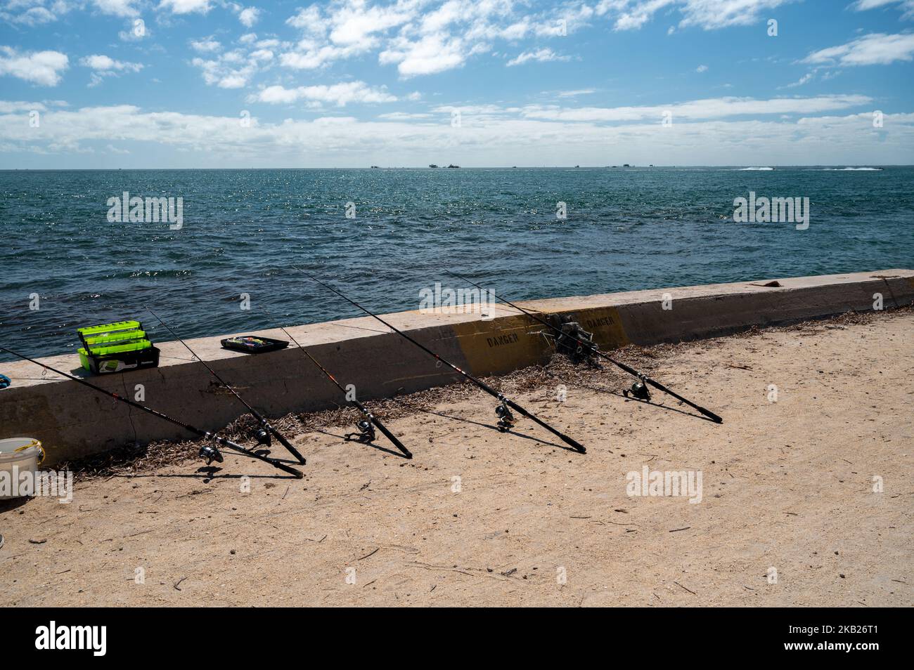 Ocean view with 4 fishing rods, Florida Stock Photo - Alamy