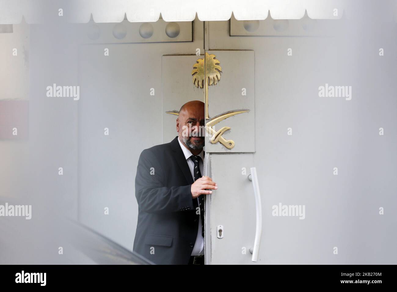 An official stands in front of the Saudi consulate in Istanbul, Turkey ...