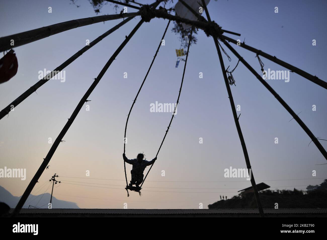 Nepalese people playing on a traditional bamboo ping or swing during ...