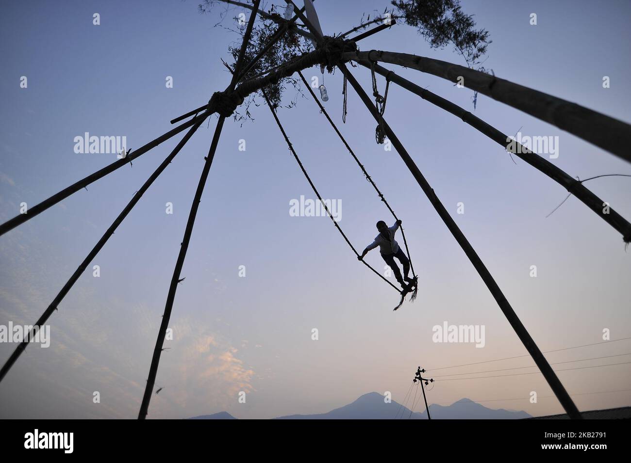 Nepalese people playing on a traditional bamboo ping or swing during ...