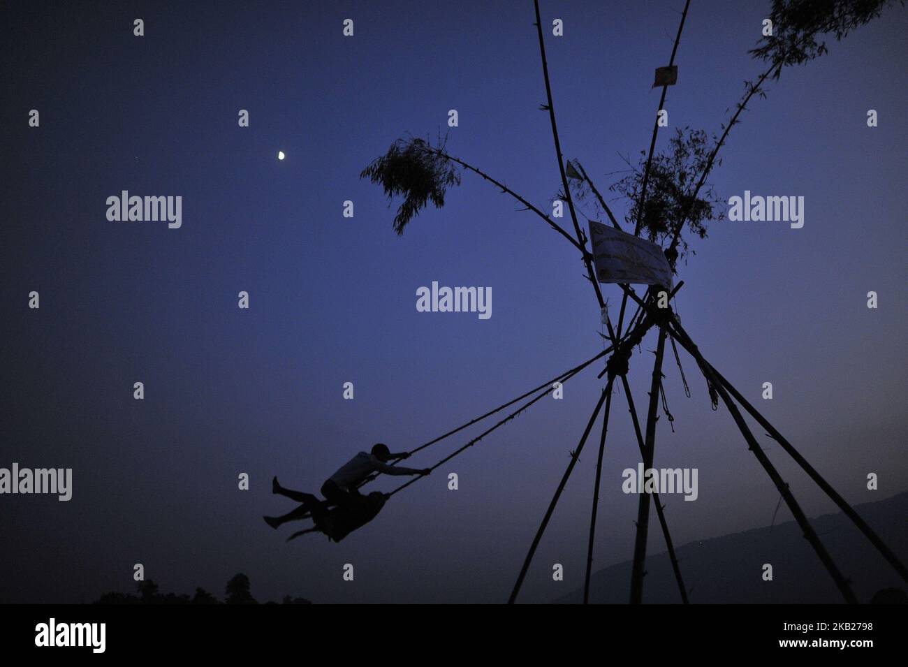 Nepalese people playing on a traditional bamboo ping or swing during ...