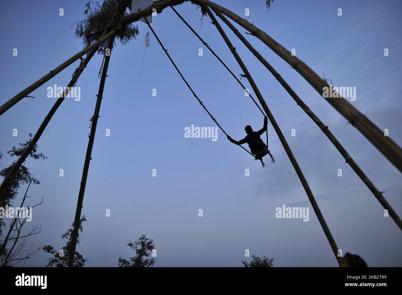 Nepalese people playing on a traditional bamboo ping or swing during ...