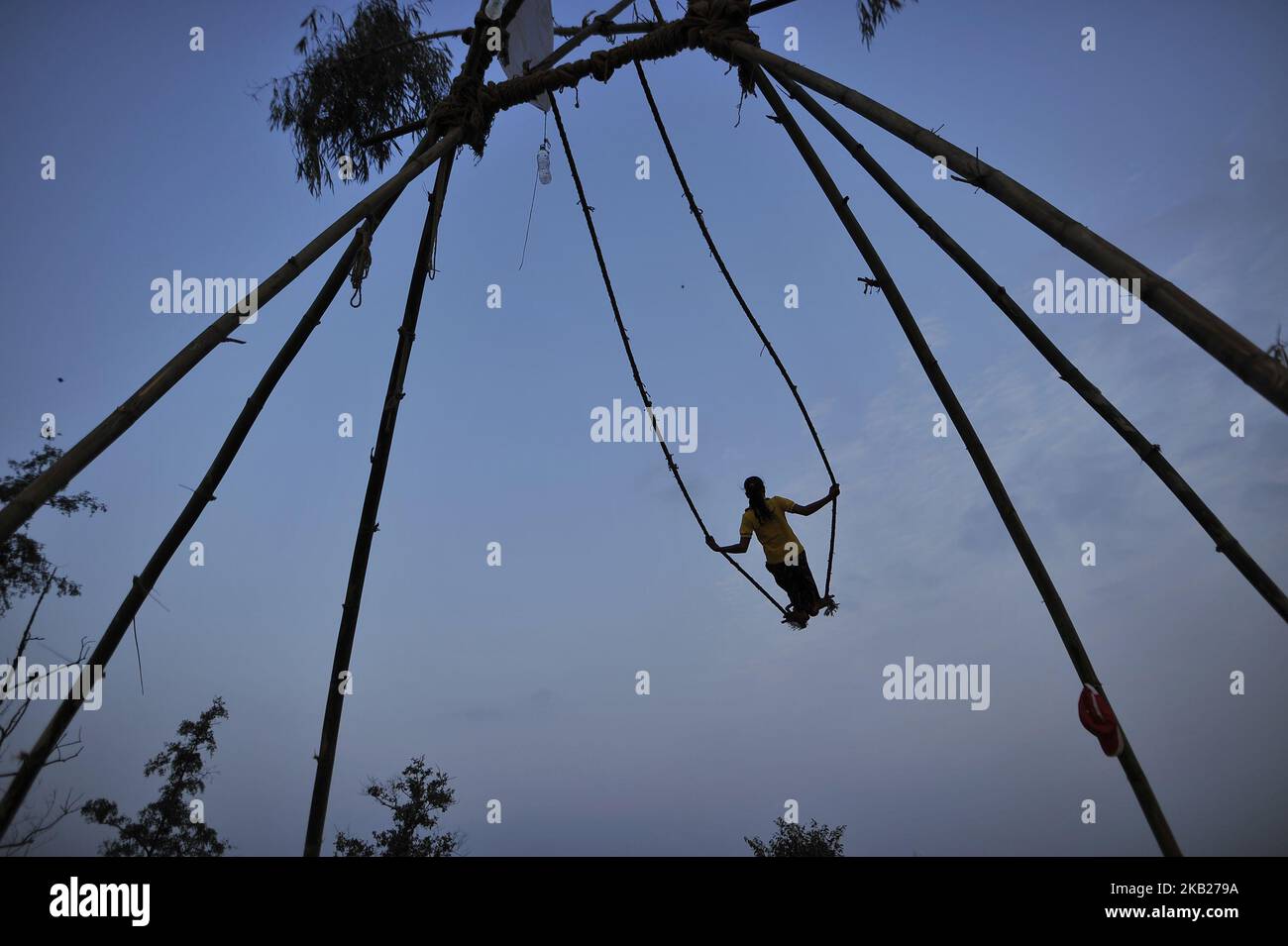 Nepalese people playing on a traditional bamboo ping or swing during ...