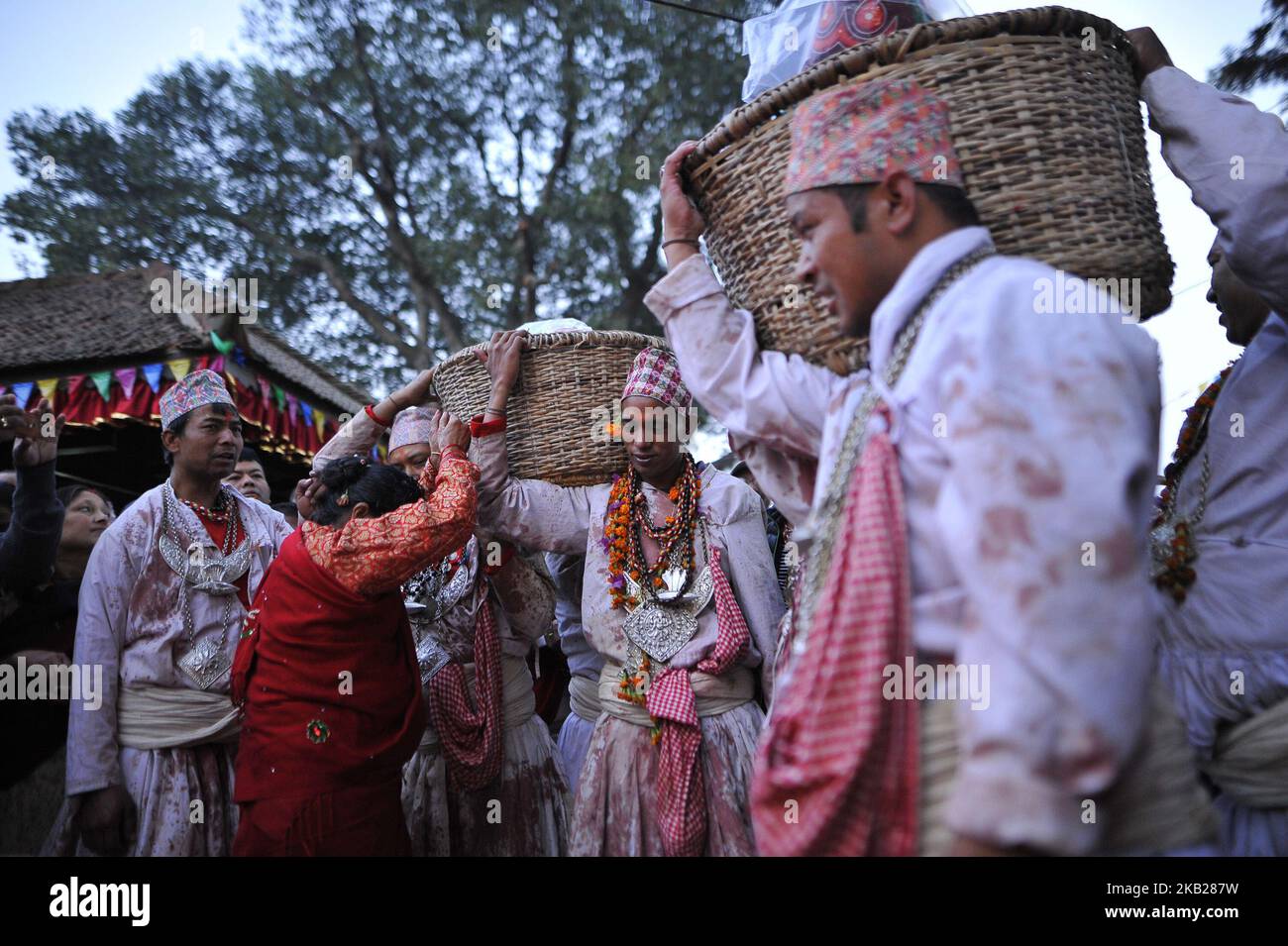 A Woman priest offering ritual procession towards ritual mask of deity ...