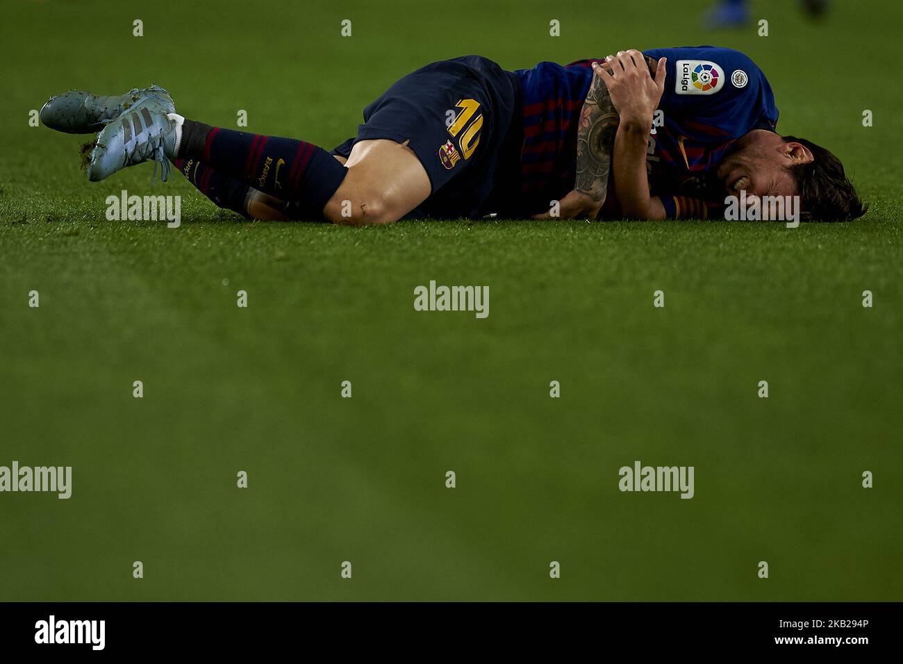 Lionel Messi lies injured on the pitch during the week 9 of La Liga ...
