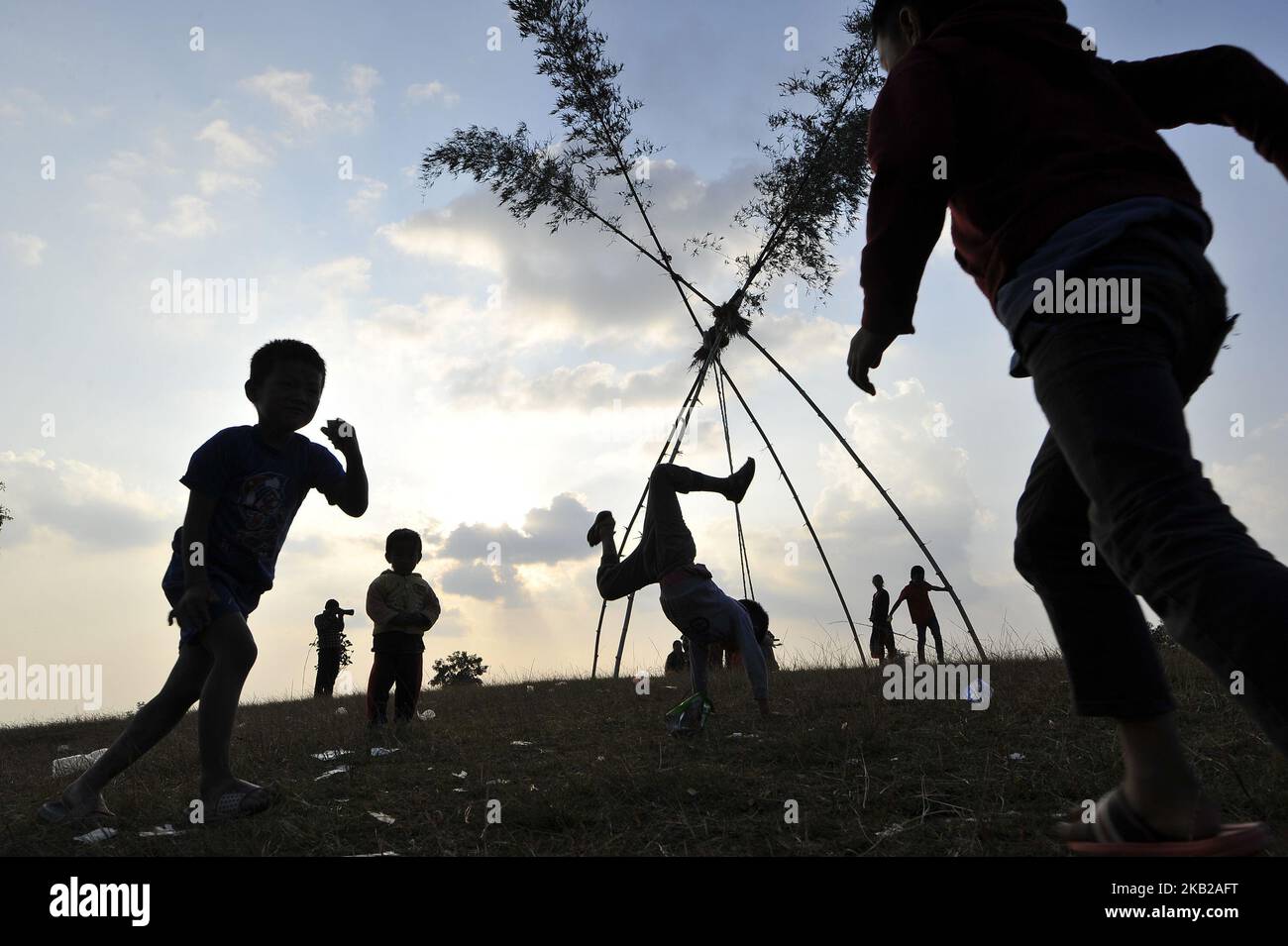 Kids Playing as a Nepalese girls play on a traditional bamboo ping or ...