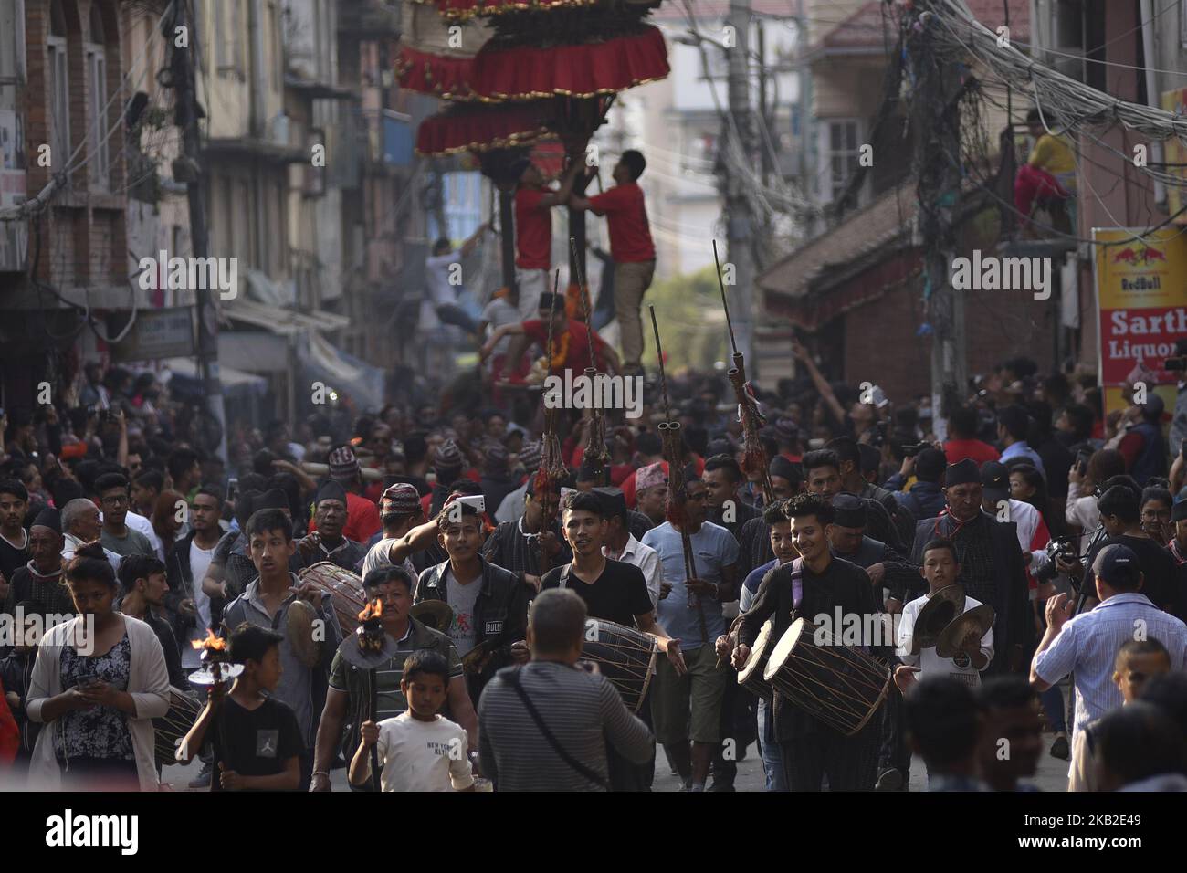 Devotees playing traditional drums as Locals carry and rotates top part ...