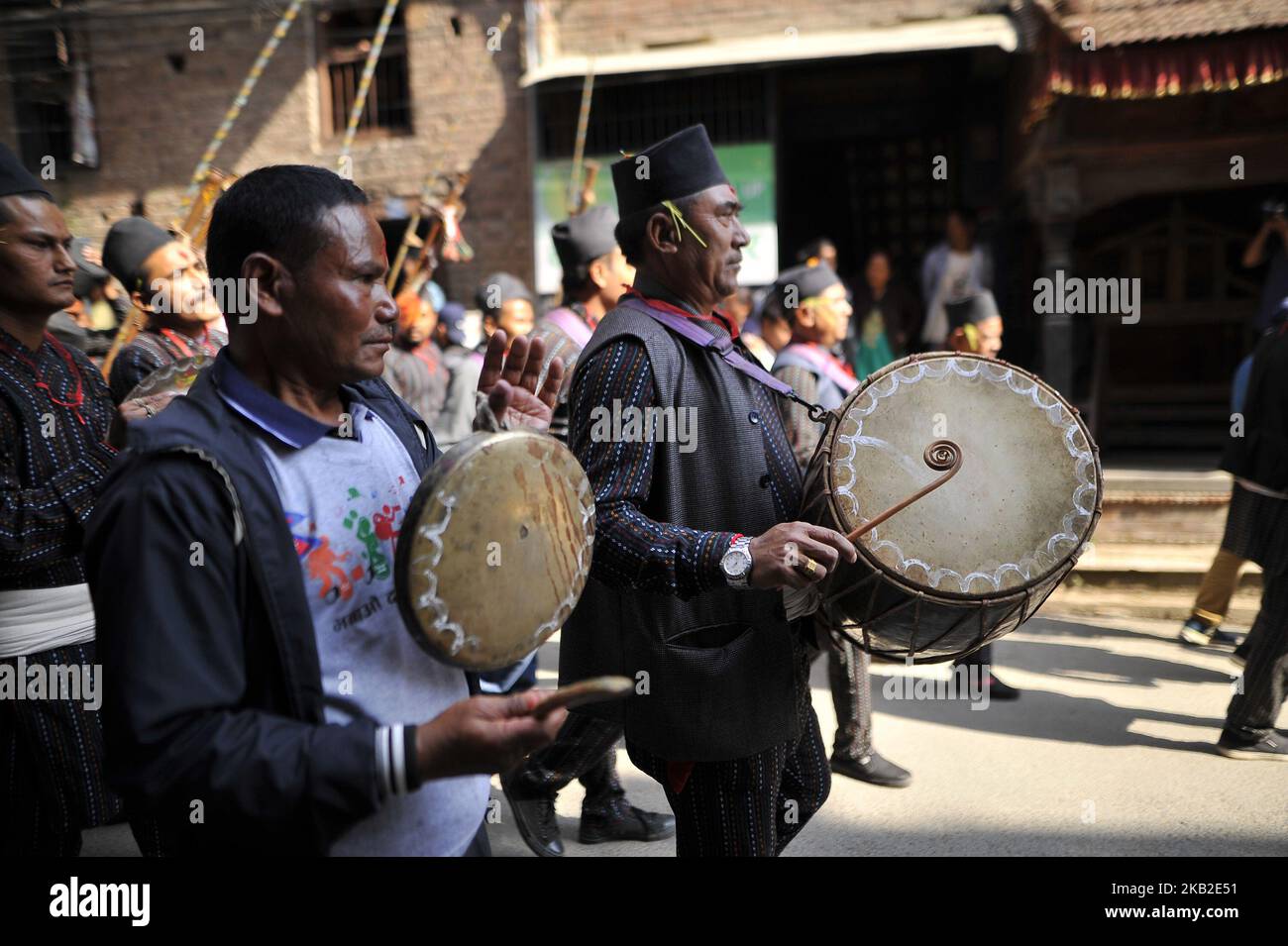 Devotees playing traditional drums as Locals carry and rotates top part ...