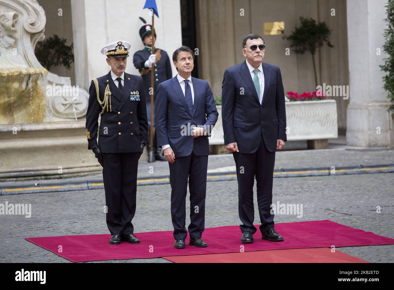 Italy's Prime Minister Giuseppe Conte (C) welcomes the Chairman of the ...